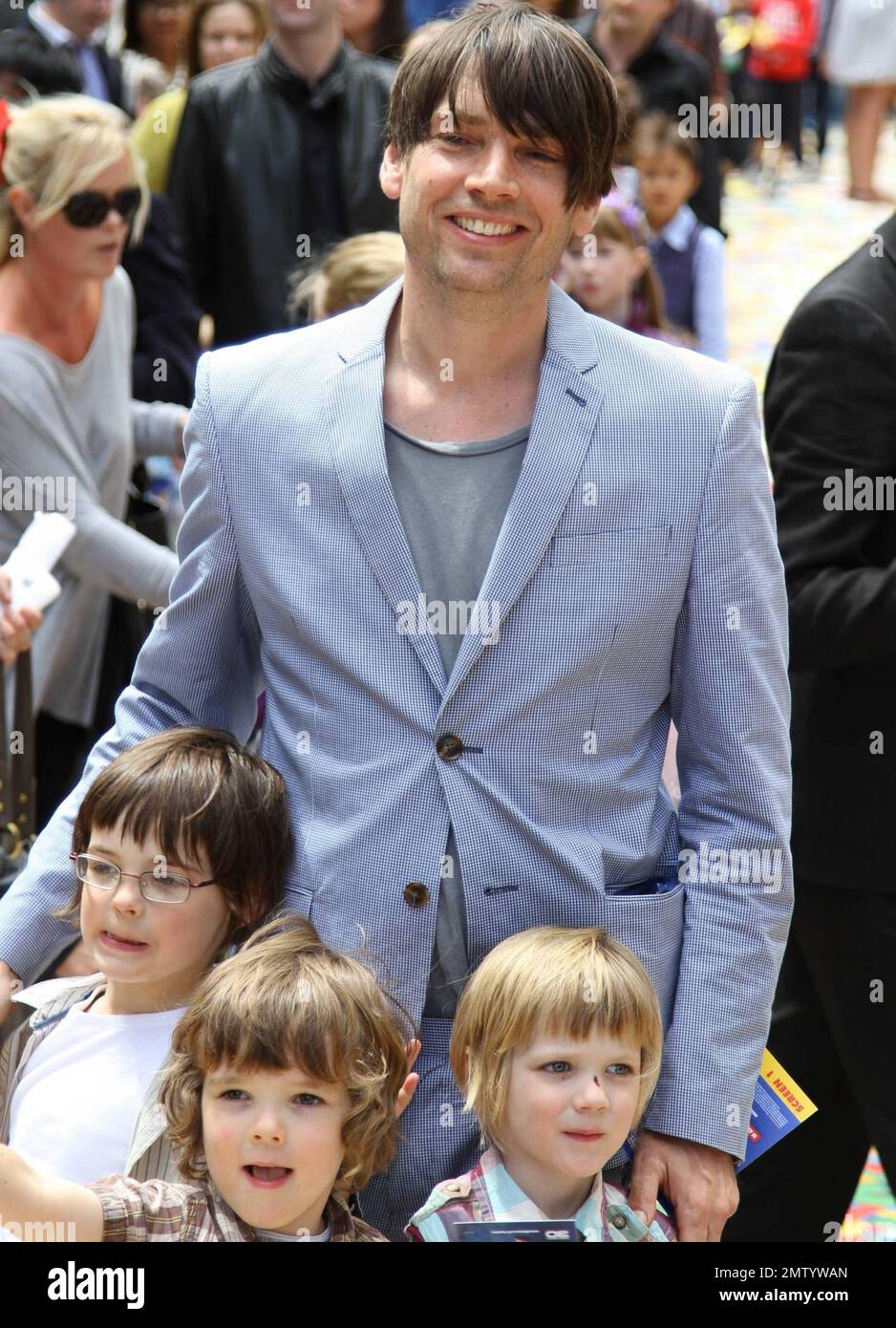 Blur bassist Alex James gives a big smile and hugs his sons Geronimo ...