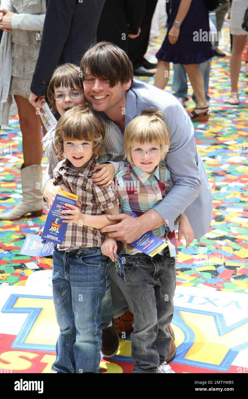 Blur bassist Alex James gives a big smile and hugs his sons Geronimo ...