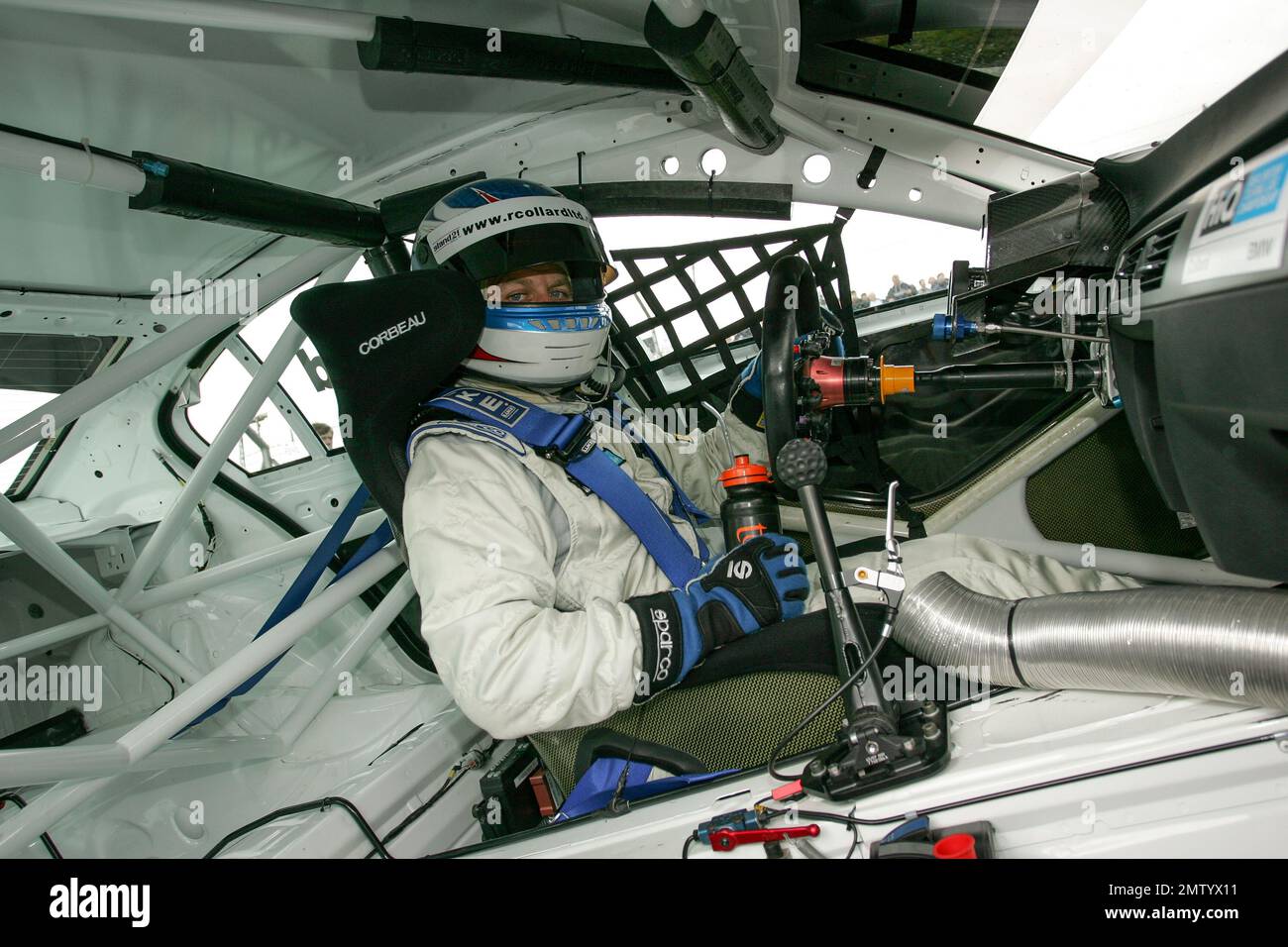 Racing driver Rob Collard sits strapped in the cockpit of his BMW on ...