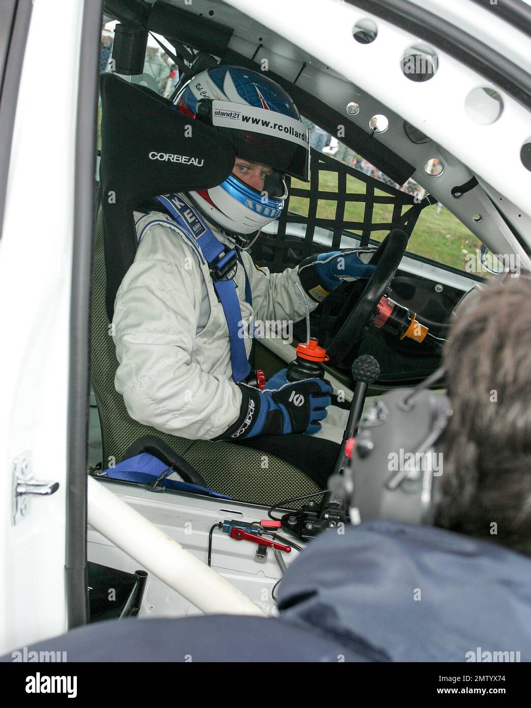 Racing driver Rob Collard sits strapped in the cockpit of his BMW on ...