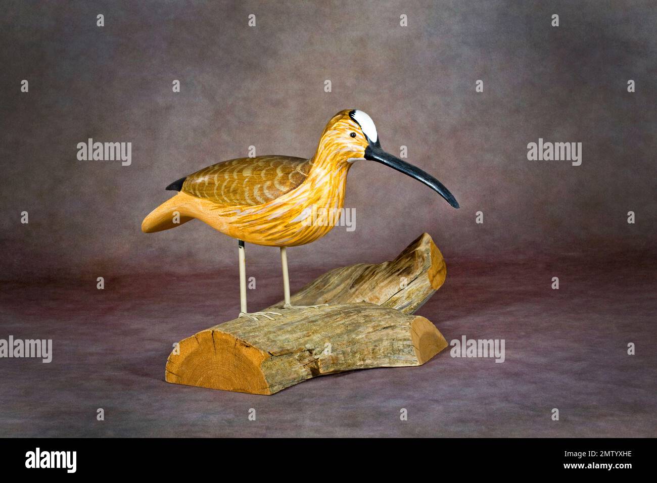 A hand carved, wooden Curlew mounted on driftwood, created by legendary ...