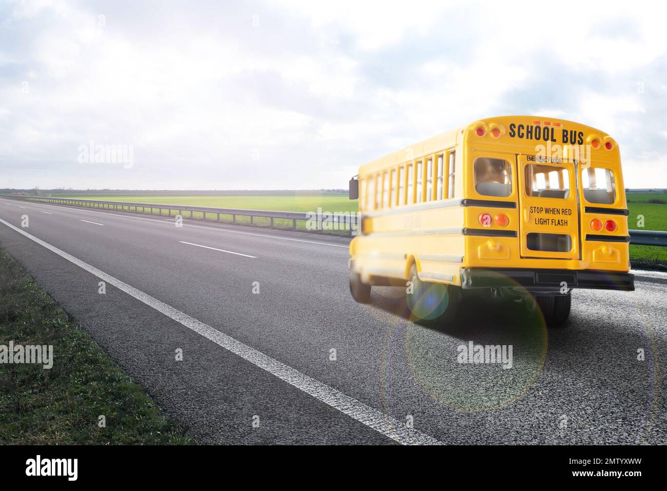 Yellow school bus on road outdoors. Transport for students Stock Photo ...