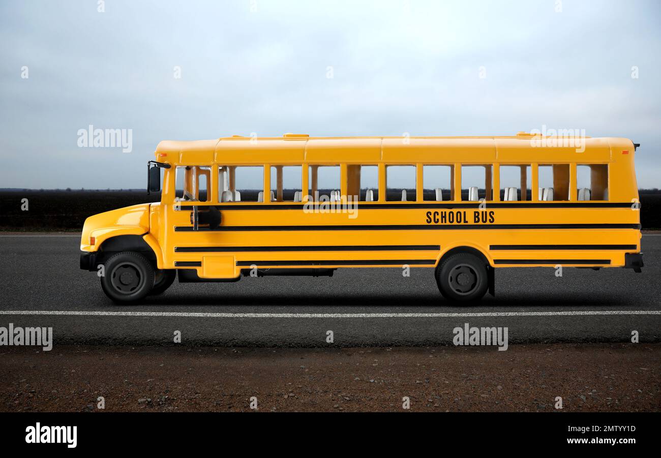 Yellow school bus on road outdoors. Transport for students Stock Photo ...