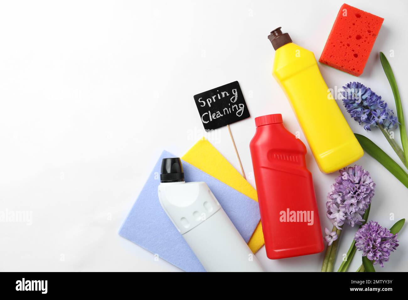 Composition with Spring Cleaning sign, flowers and detergents on white ...