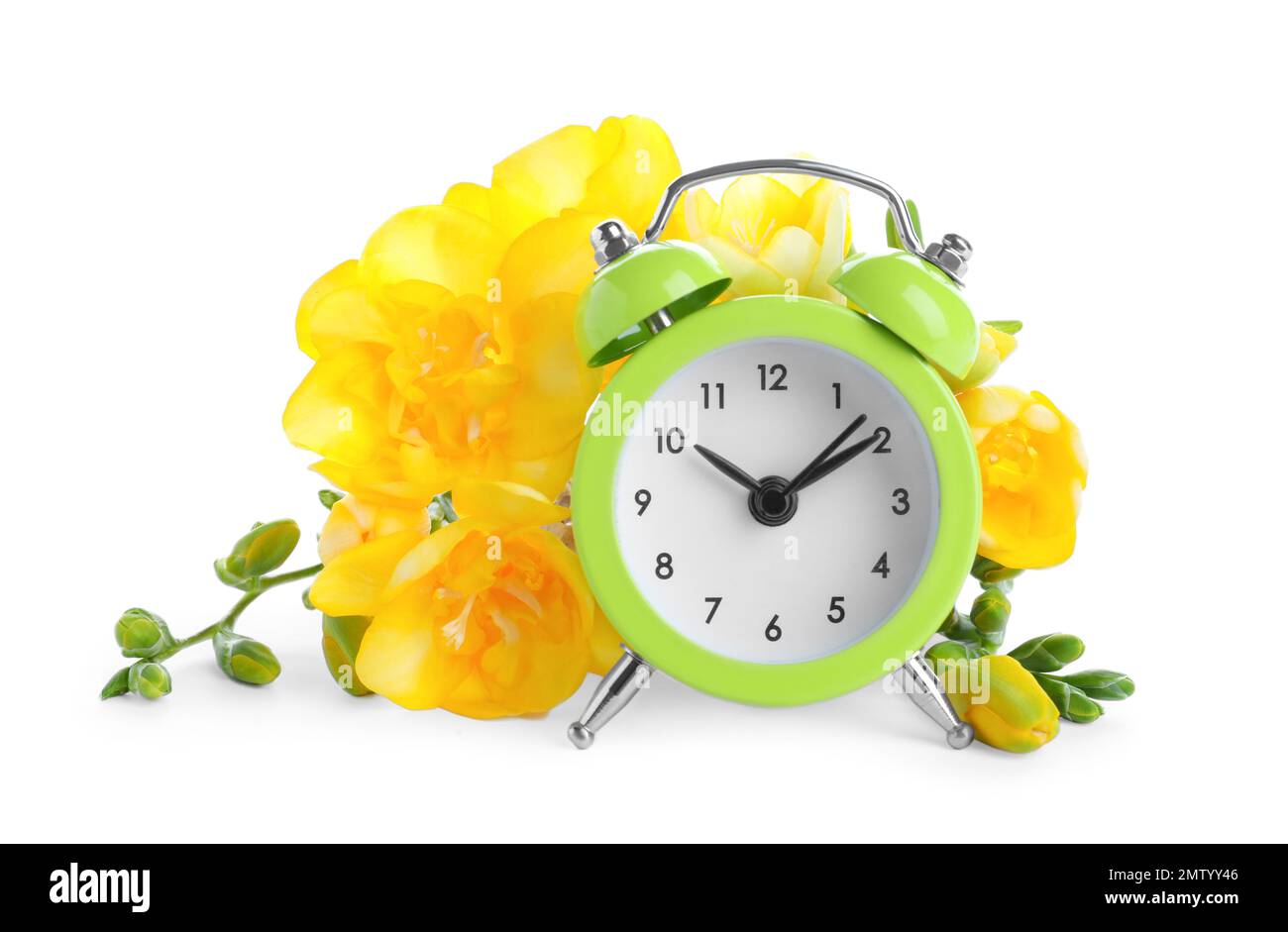 Green alarm clock and spring flowers on white background. Time change ...