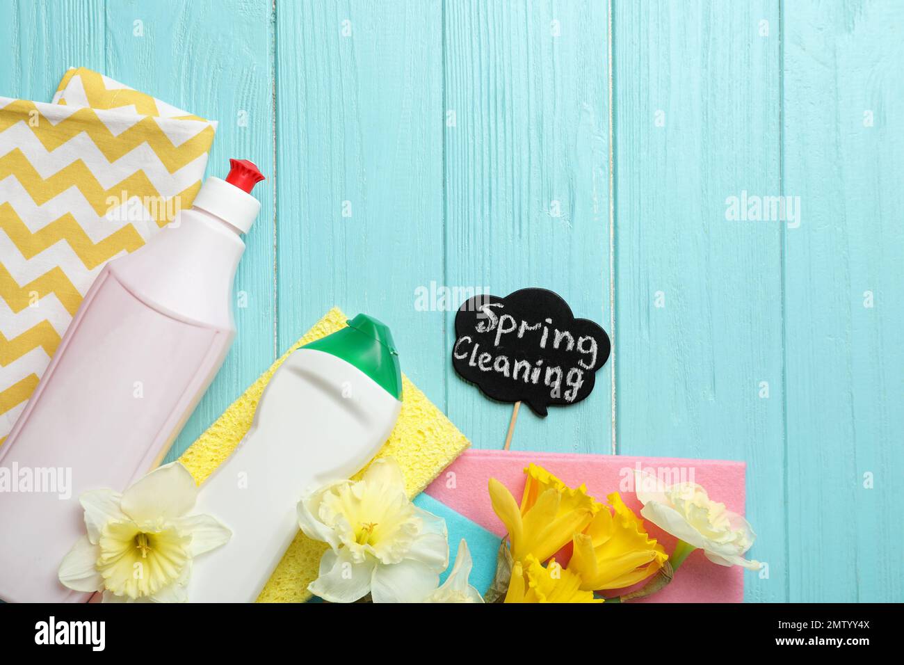 Composition with Spring Cleaning sign, flowers and detergents on light ...