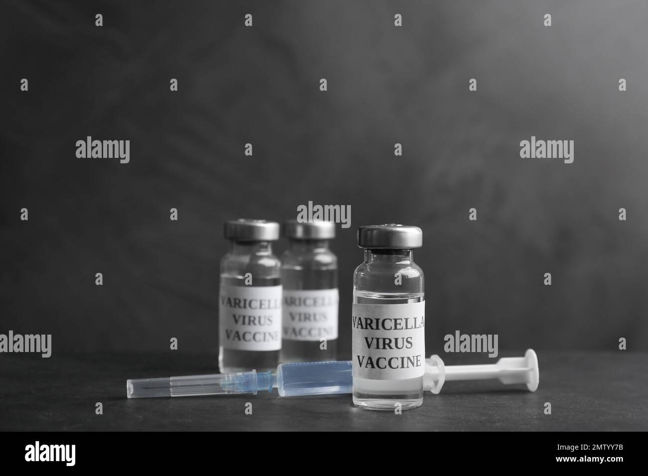 Chickenpox vaccine and syringe on grey background. Varicella virus ...