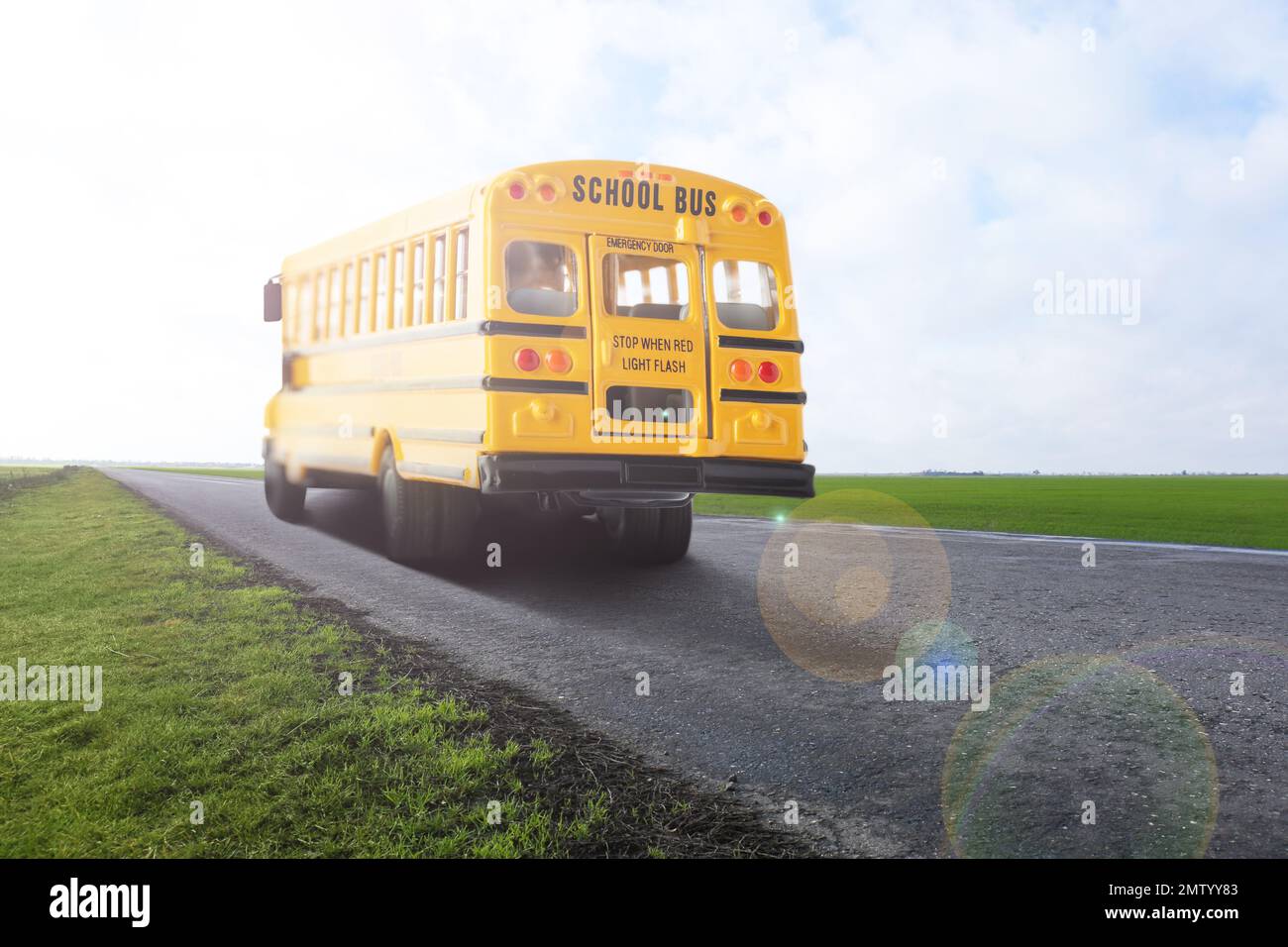 Yellow school bus on road outdoors. Transport for students Stock Photo ...