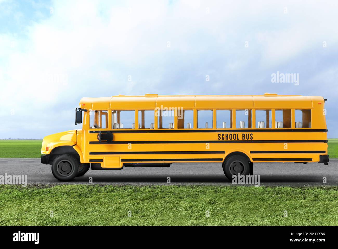 Yellow school bus on road outdoors. Transport for students Stock Photo ...