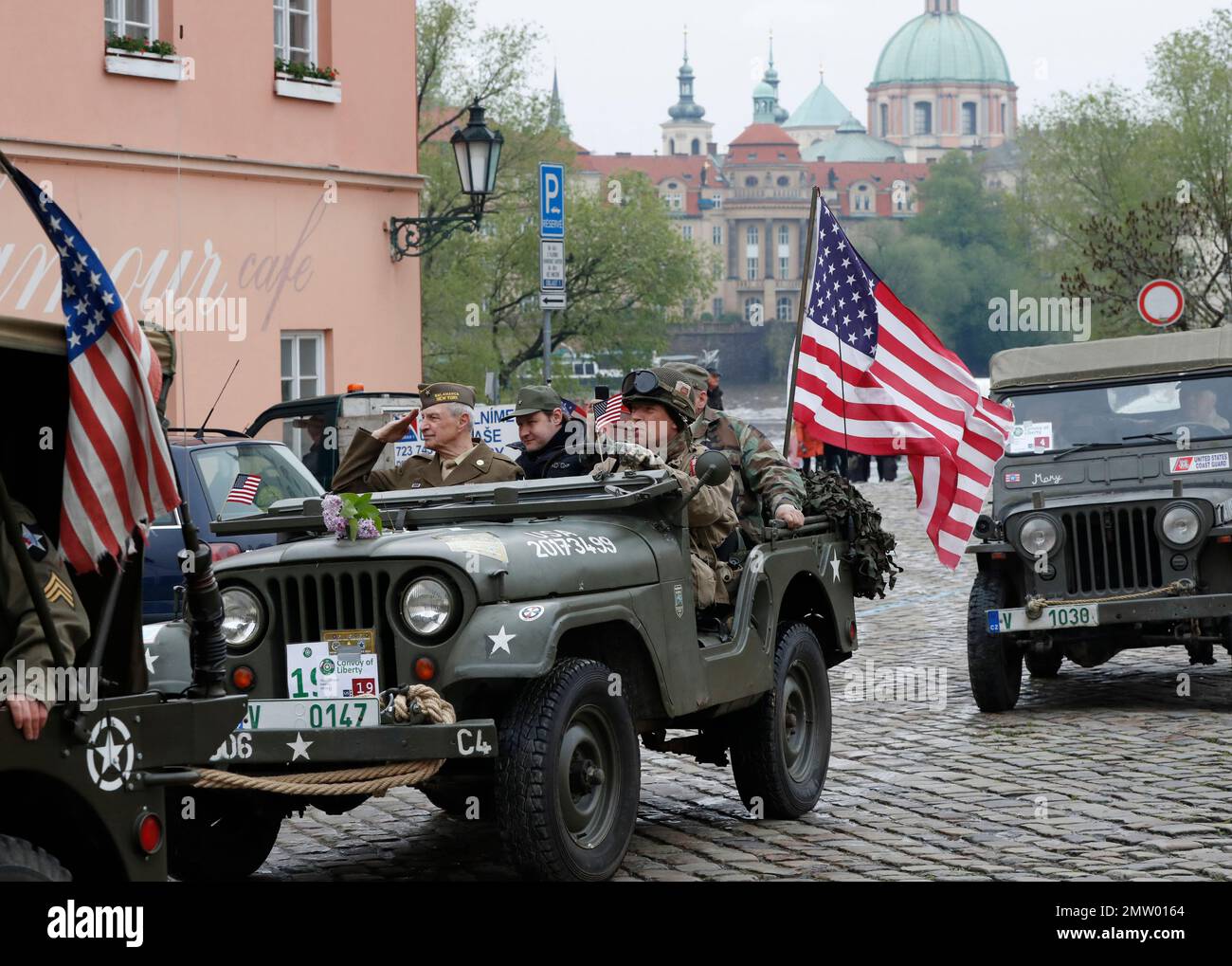 History enthusiasts dressed in U.S. Army World War II uniforms drive in ...