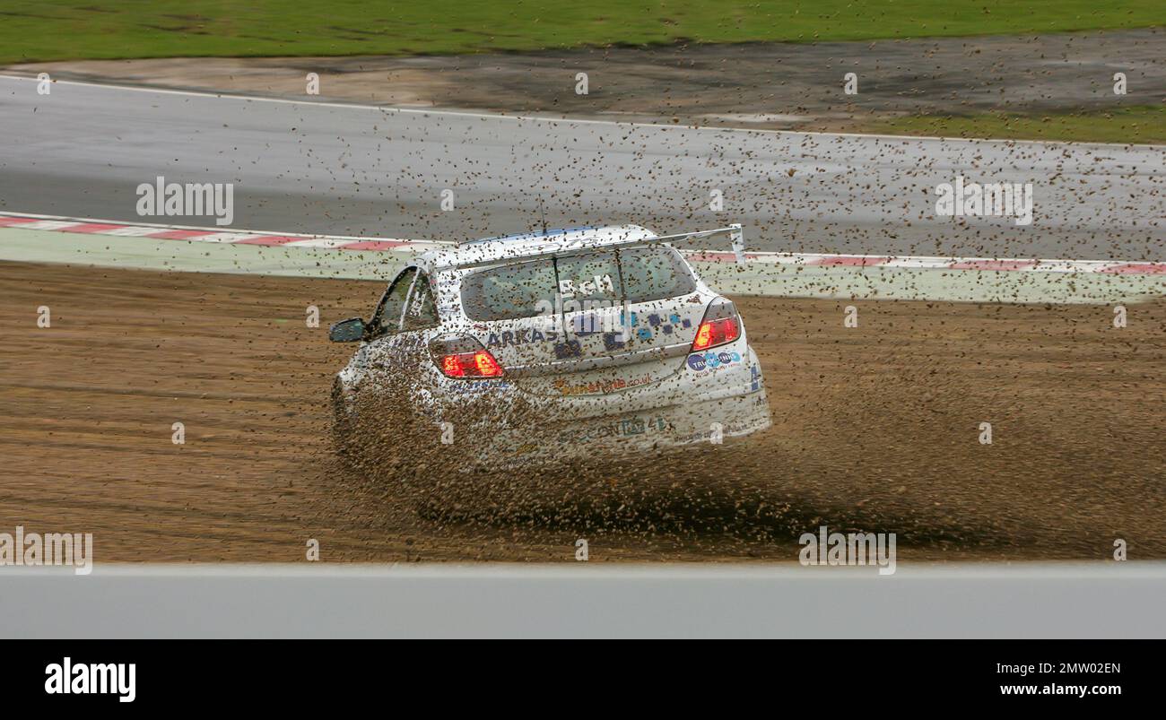 Martyn Bell spins into the gravel at Paddock Hill bend on a wet track ...