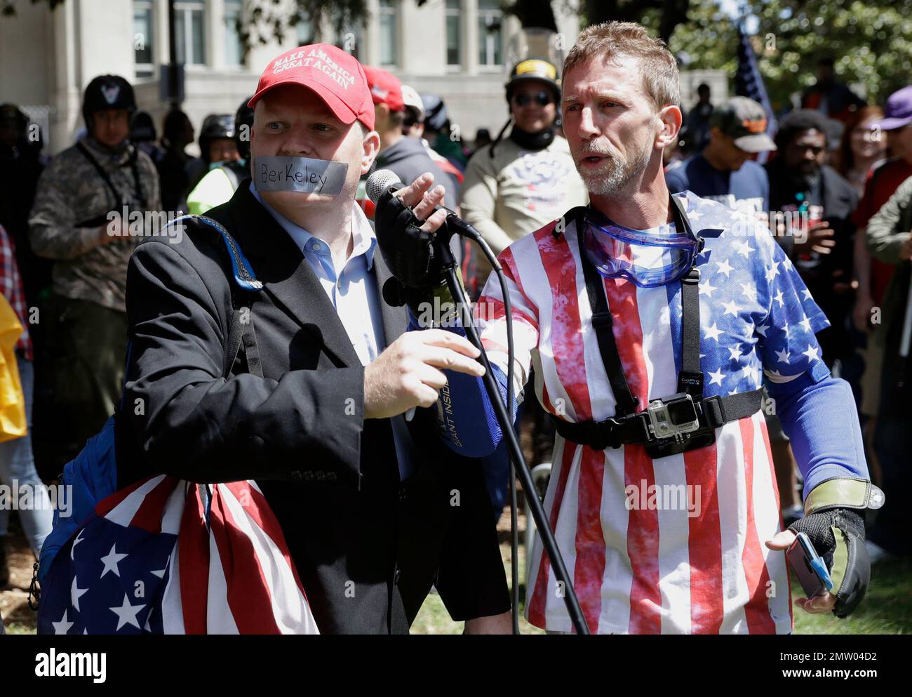 Daryl Tempesta, left, with a sign over his mouth, walks to the ...