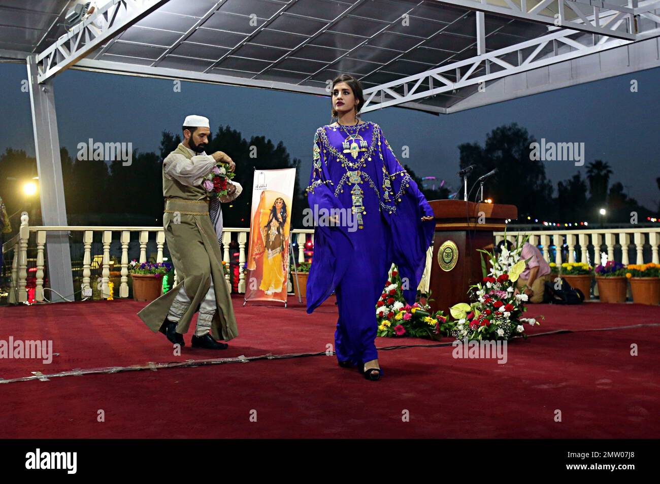 Dancers dressed in traditional Iraqi folk costumes during a flower ...