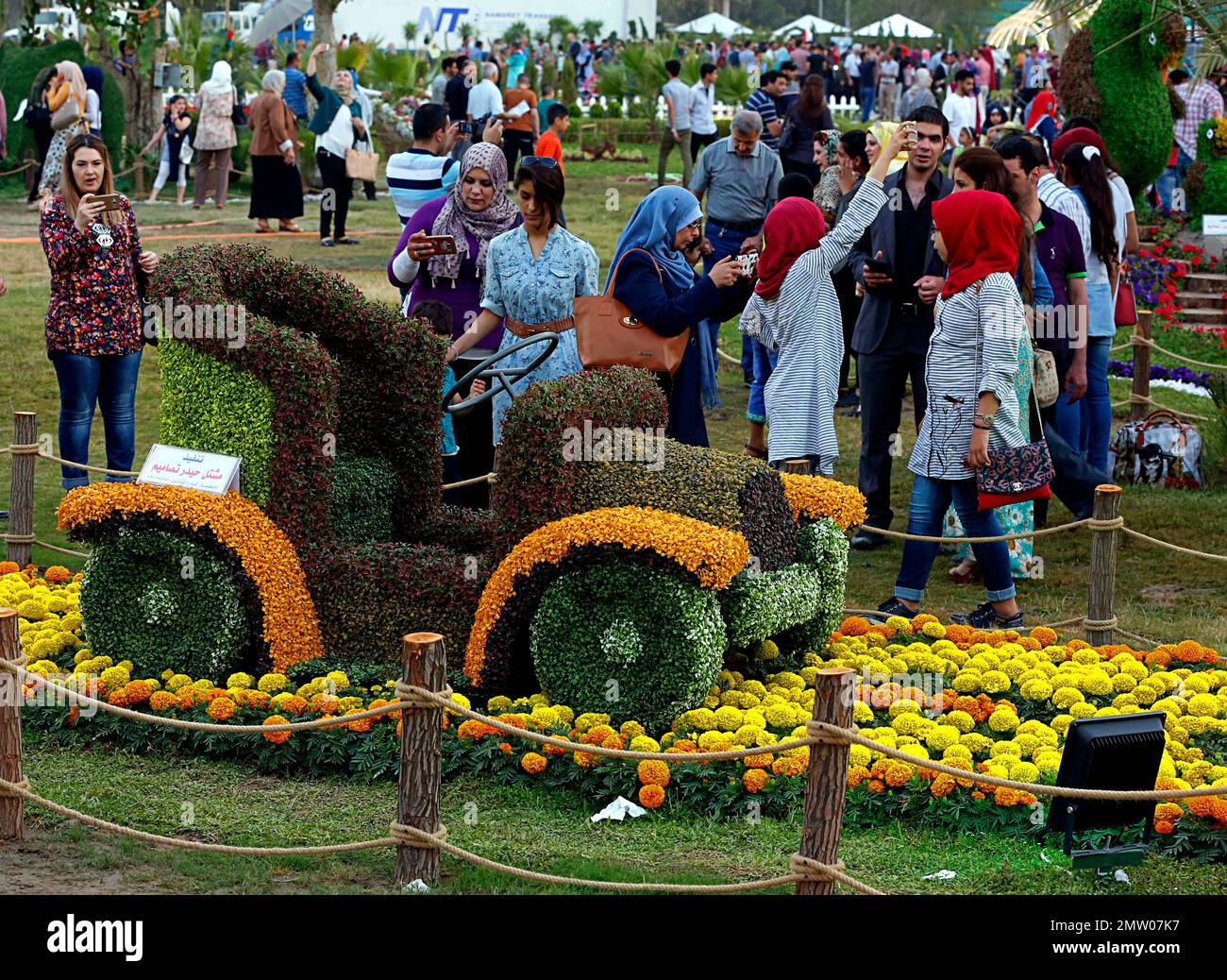 Iraqis attend a flower festival at al-Zawra Park in Baghdad, Iraq ...