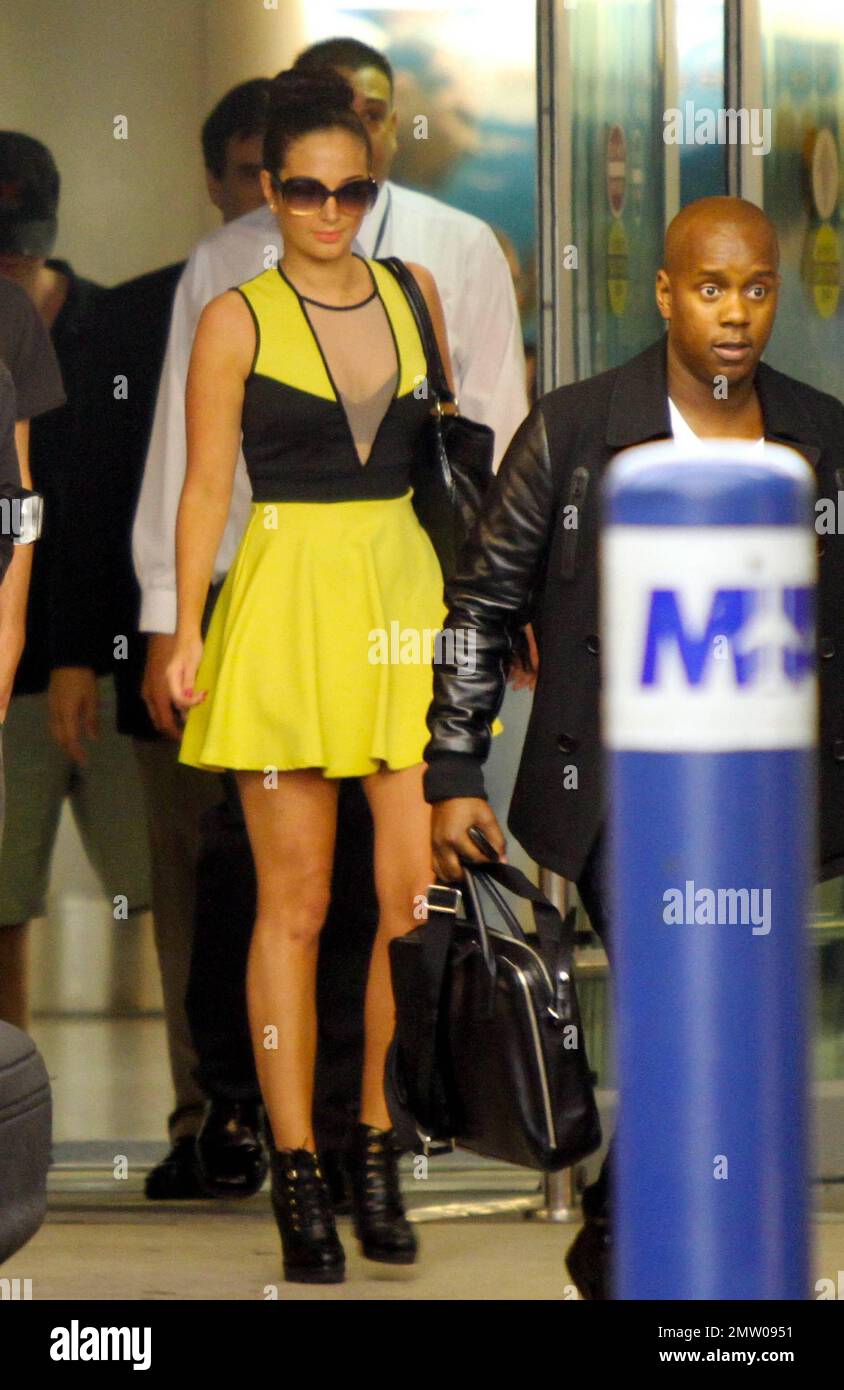 British singer Tulisa arrives in Miami wearing a yellow mini dress and black high heels. The ...