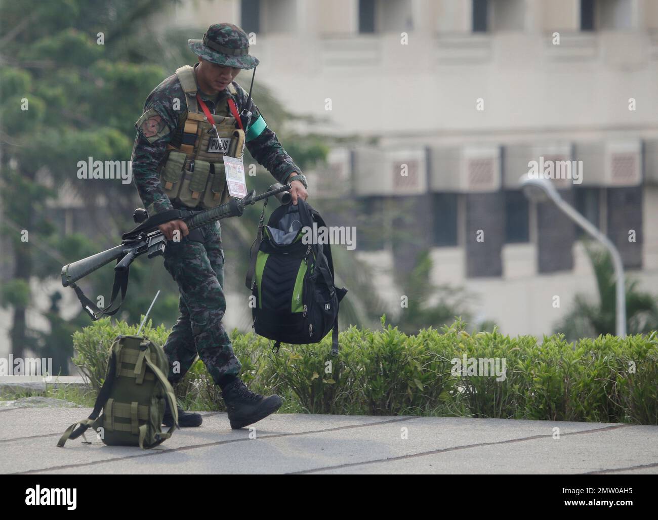 A member of the Filipino security force takes position ahead of the ...