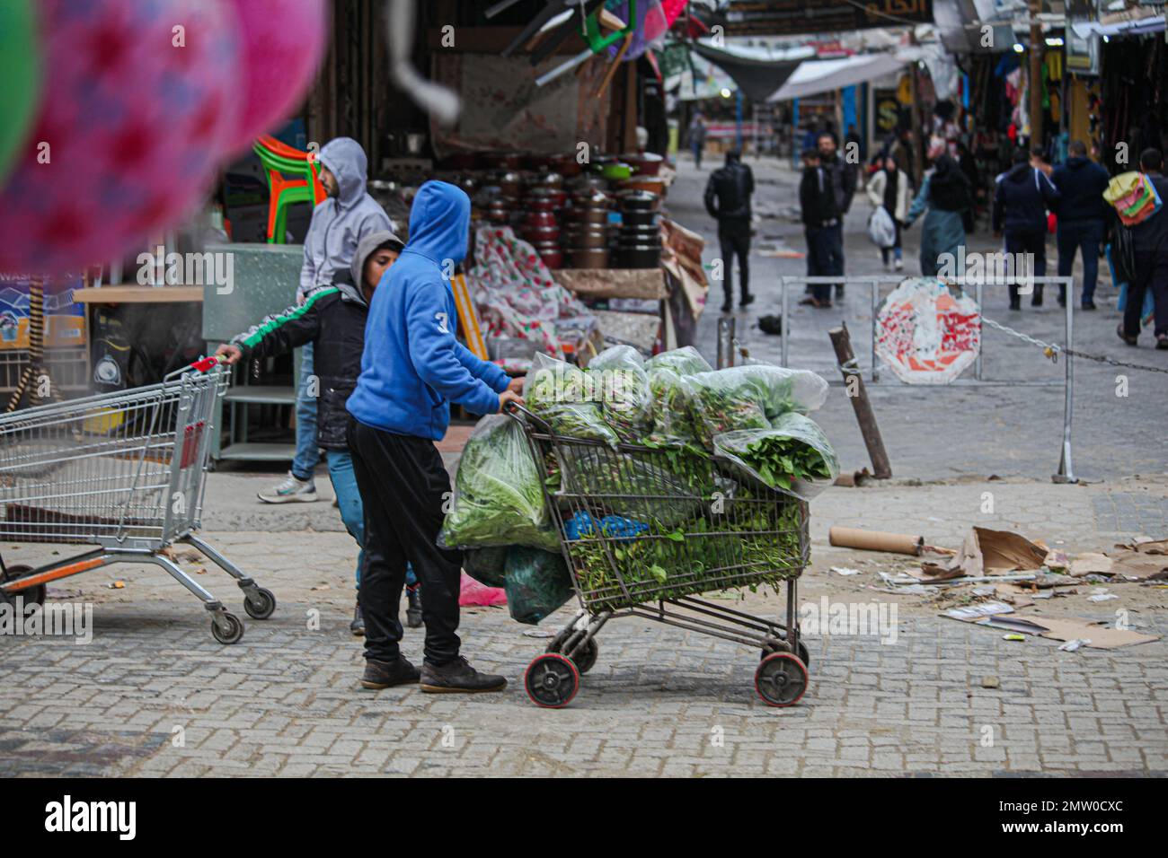 Palestinian worker pushes a pickup transport cart in the middle of the ...