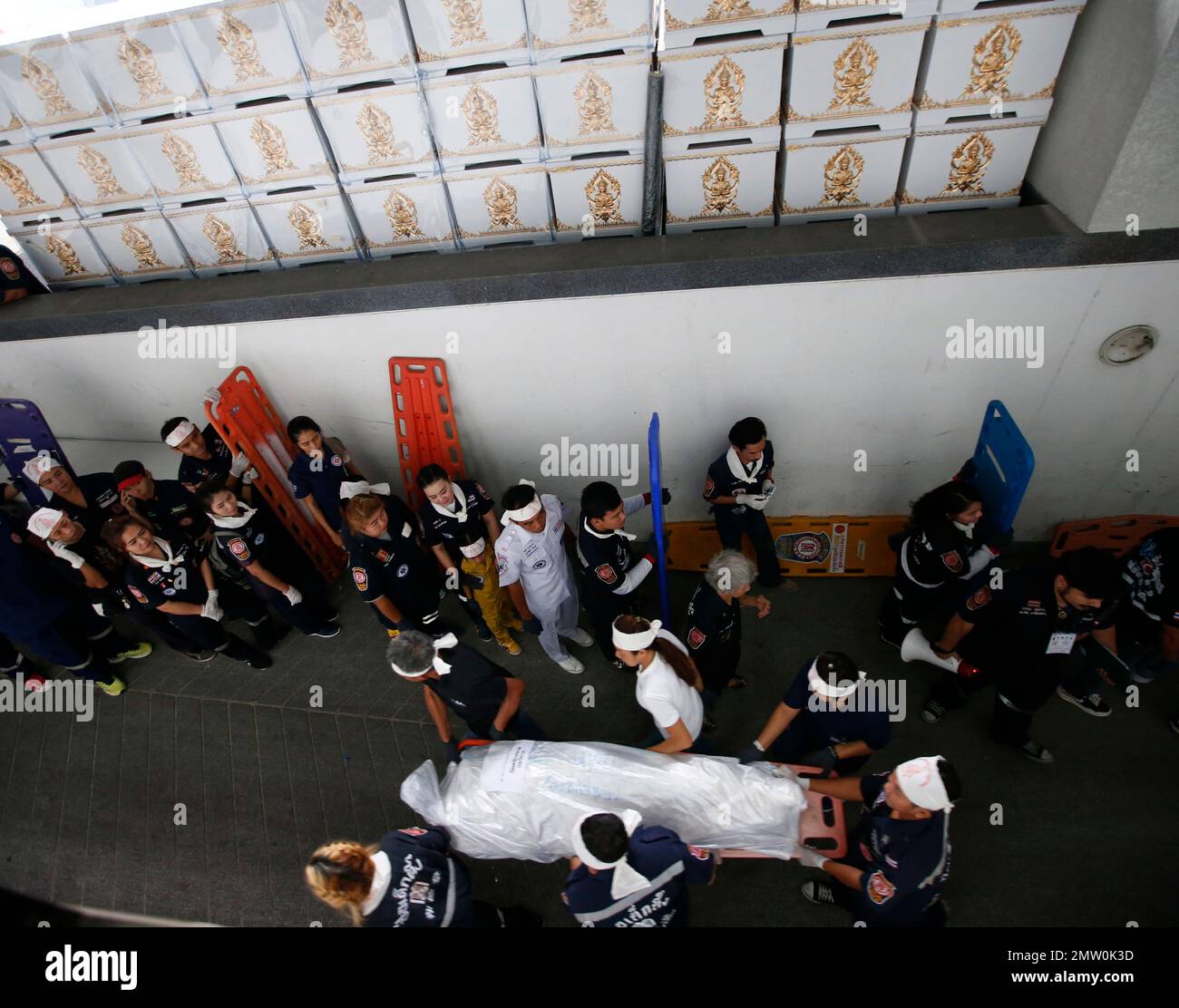 Volunteers carry a cadaver to ceremony and pay respect to those whose ...