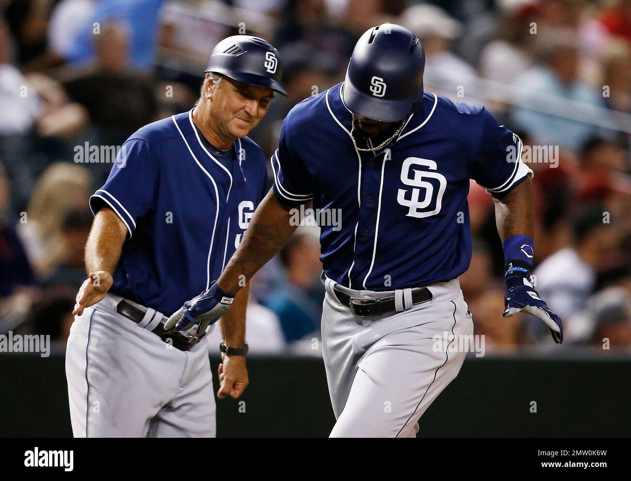 San Diego Padres' Jabari Blash, right, slaps hands with third base ...