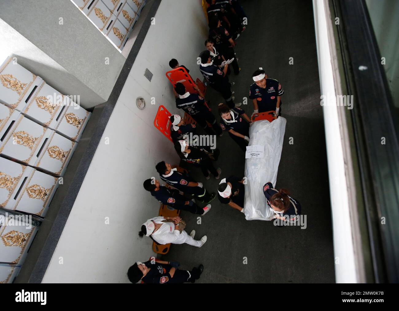 Volunteers carry a cadaver to ceremony and pay respect to those whose ...