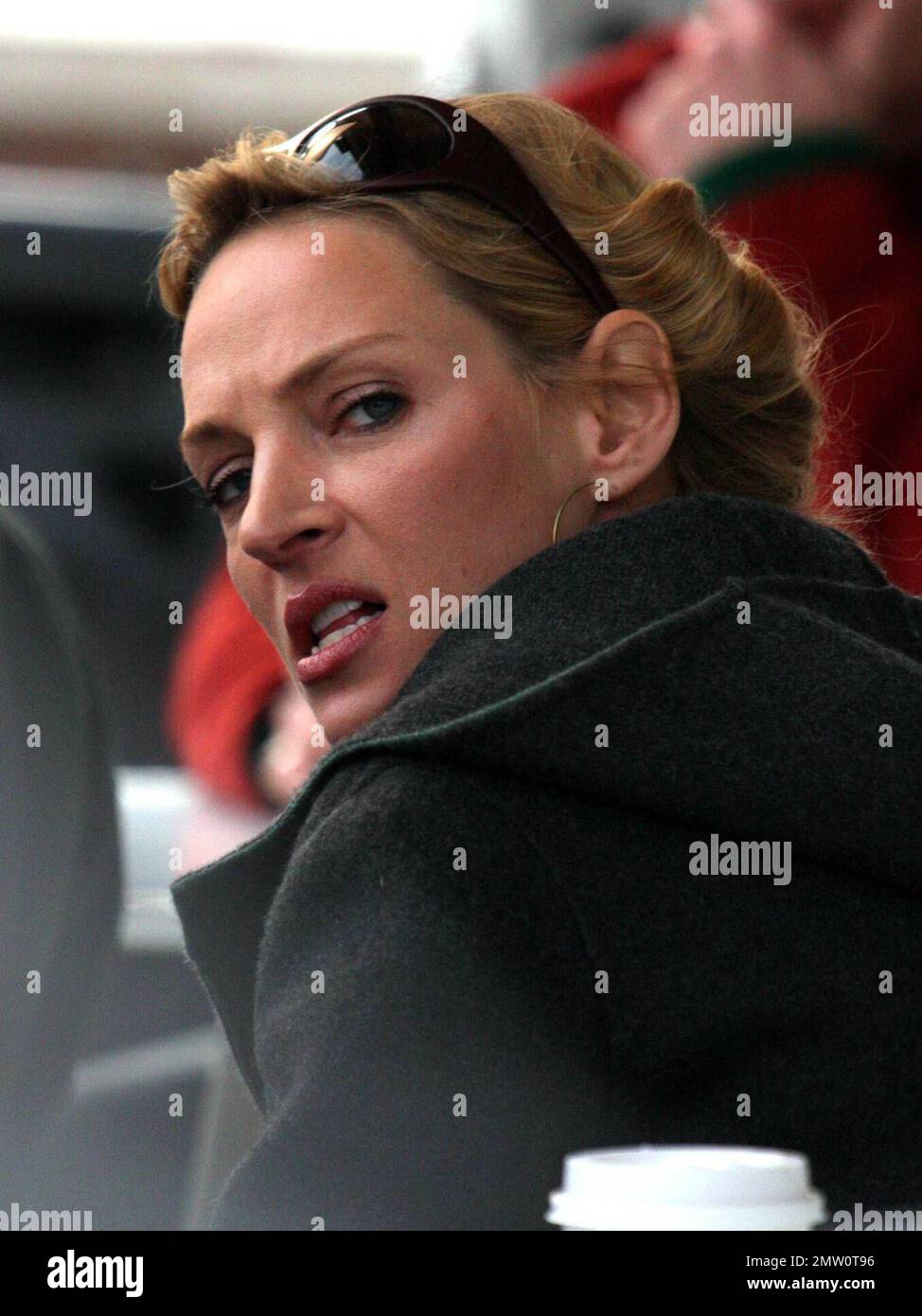 Uma Thurman takes a stroll down Main Street hiding her cigarette in one ...