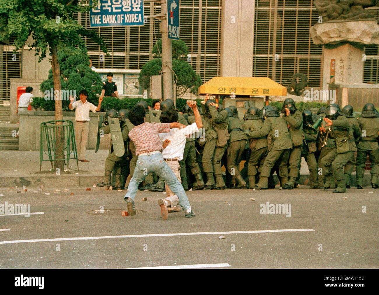 Two students throw projectiles at riot police during violent protests ...