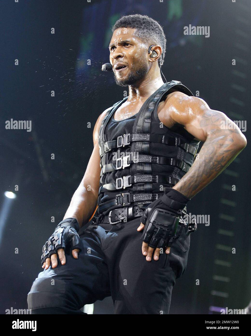 With sweat pouring from his face and clad in a buckle-detailed vest ...