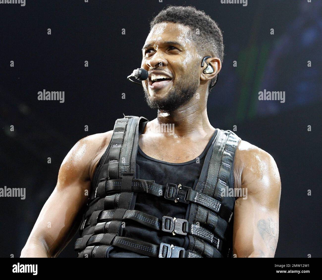 With sweat pouring from his face and clad in a buckle-detailed vest ...