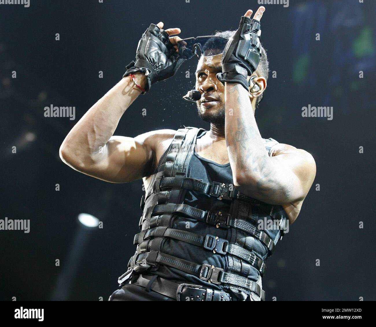 With sweat pouring from his face and clad in a buckle-detailed vest ...