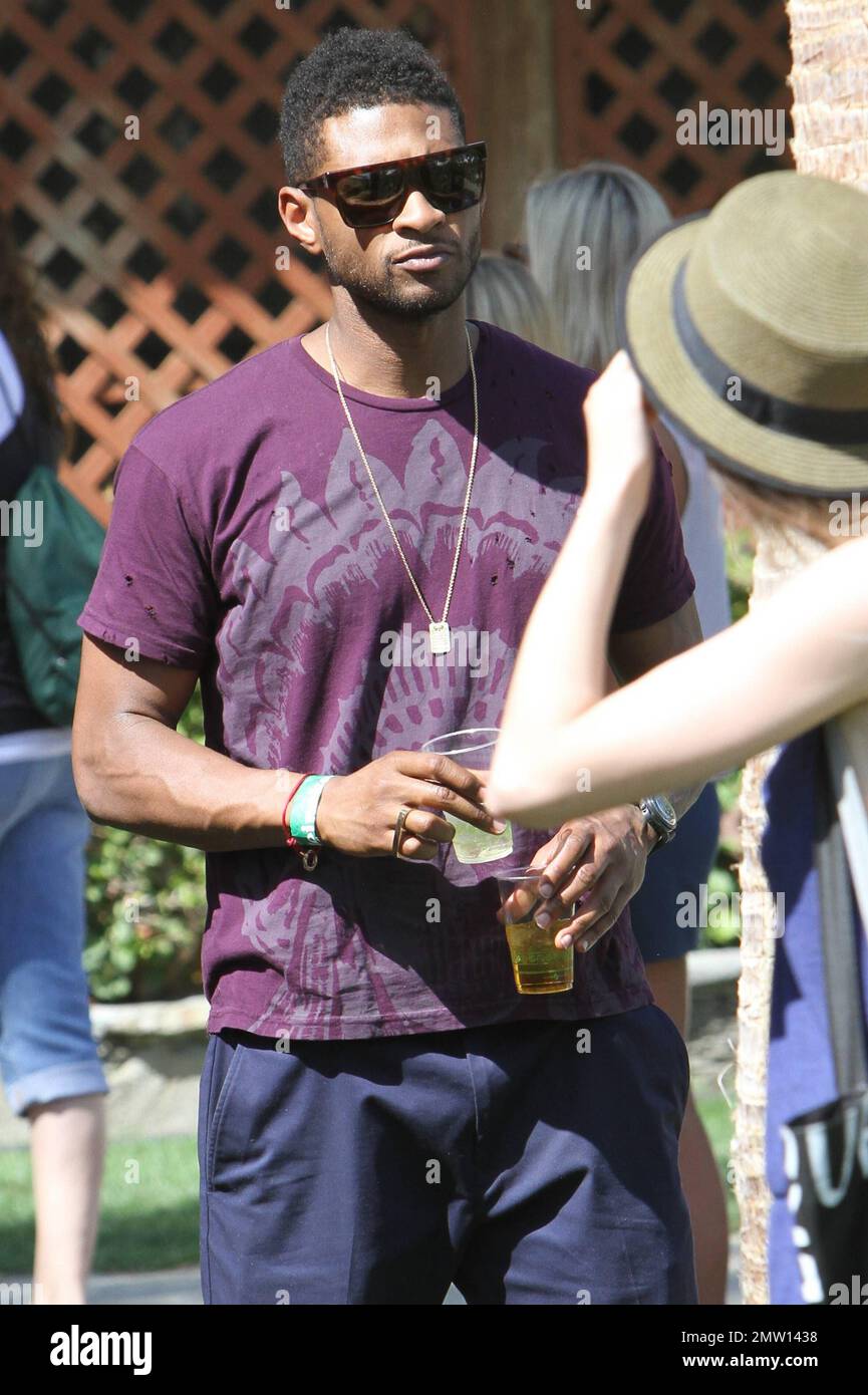 Usher wears a two-finger ring and sips on a drink on Day one of ...