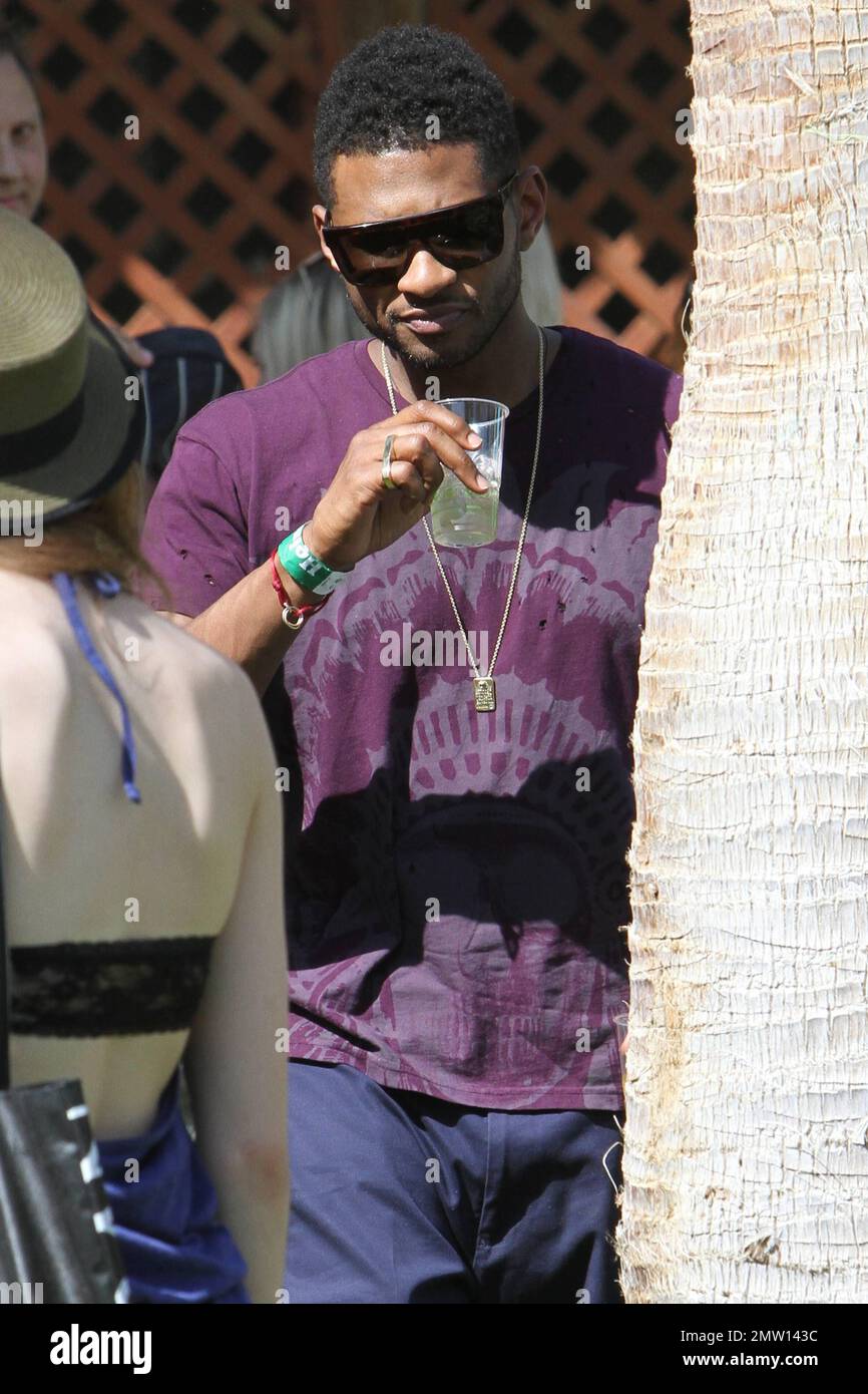Usher wears a two-finger ring and sips on a drink on Day one of ...