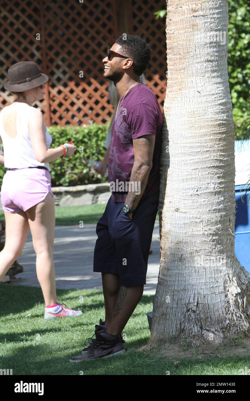Usher wears a two-finger ring and sips on a drink on Day one of ...