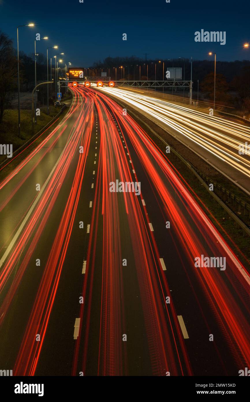 Speeding traffic on M42 motorway during evening rush hour leaves light ...
