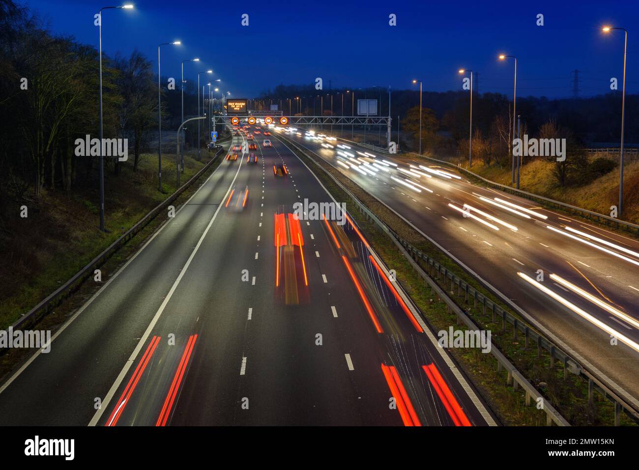 Speeding traffic creates light trails as it moves through a section of ...