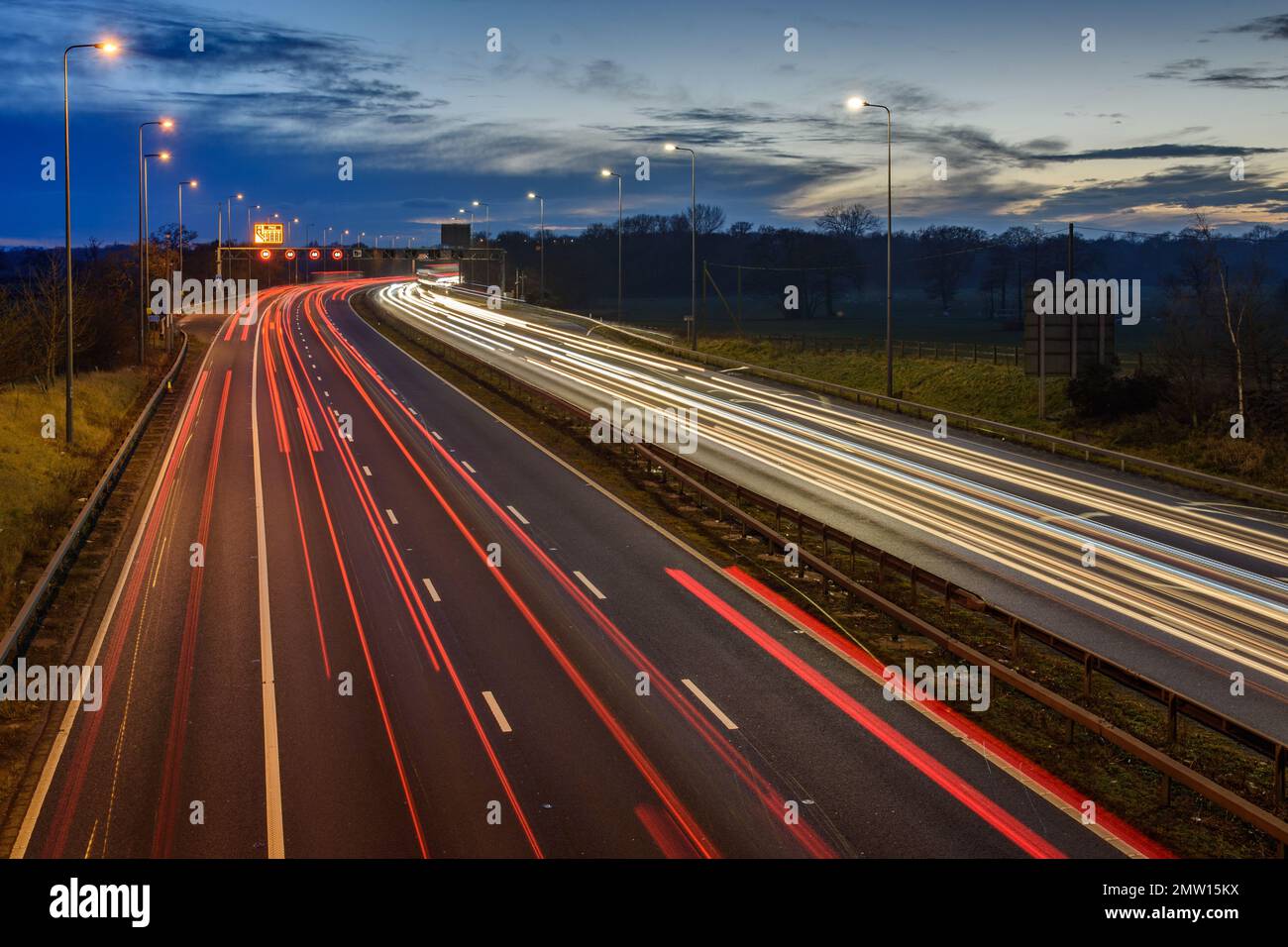 Speeding traffic on M42 motorway during evening rush hour leaves light ...