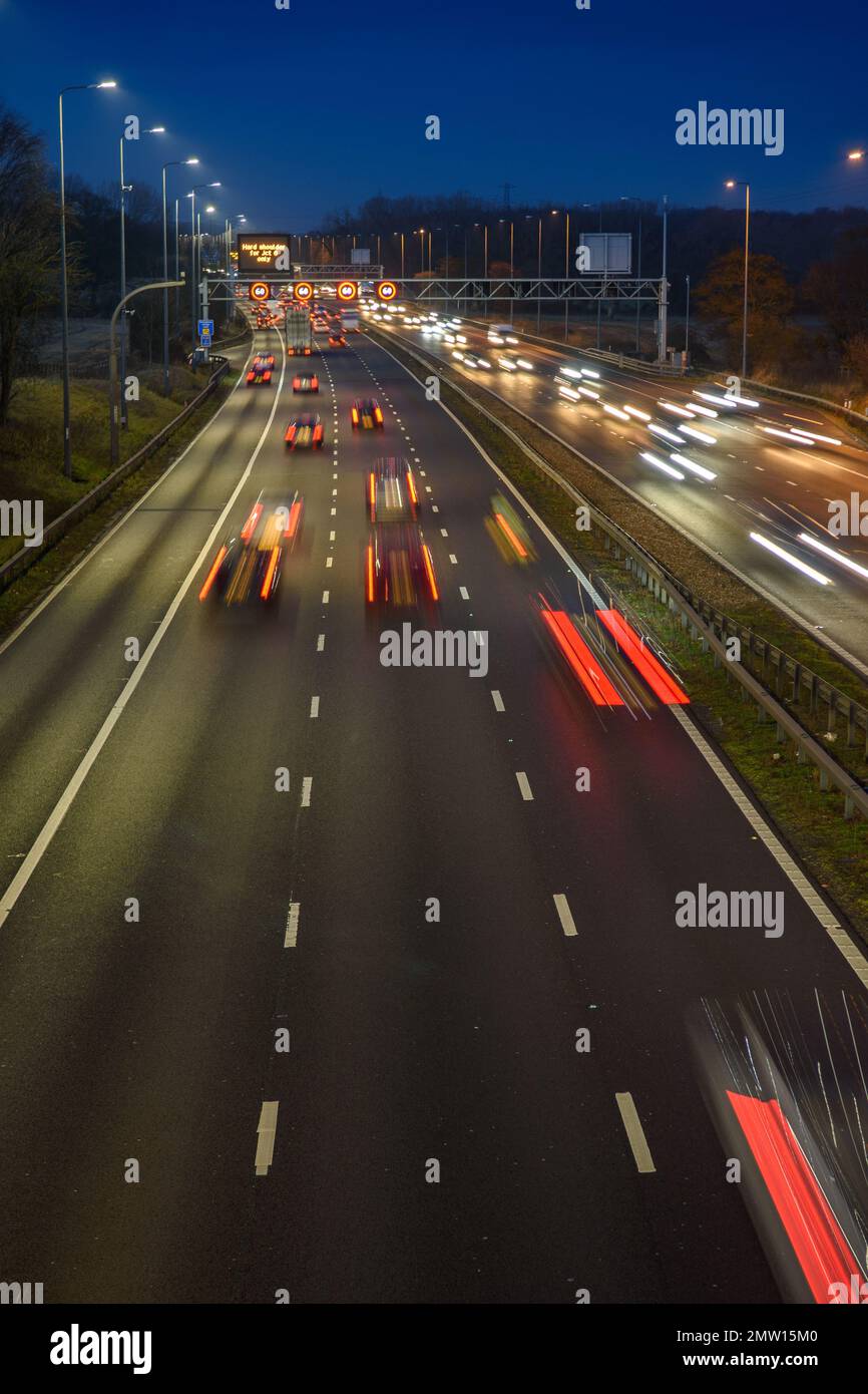 Speeding traffic creates light trails as it moves through a section of ...