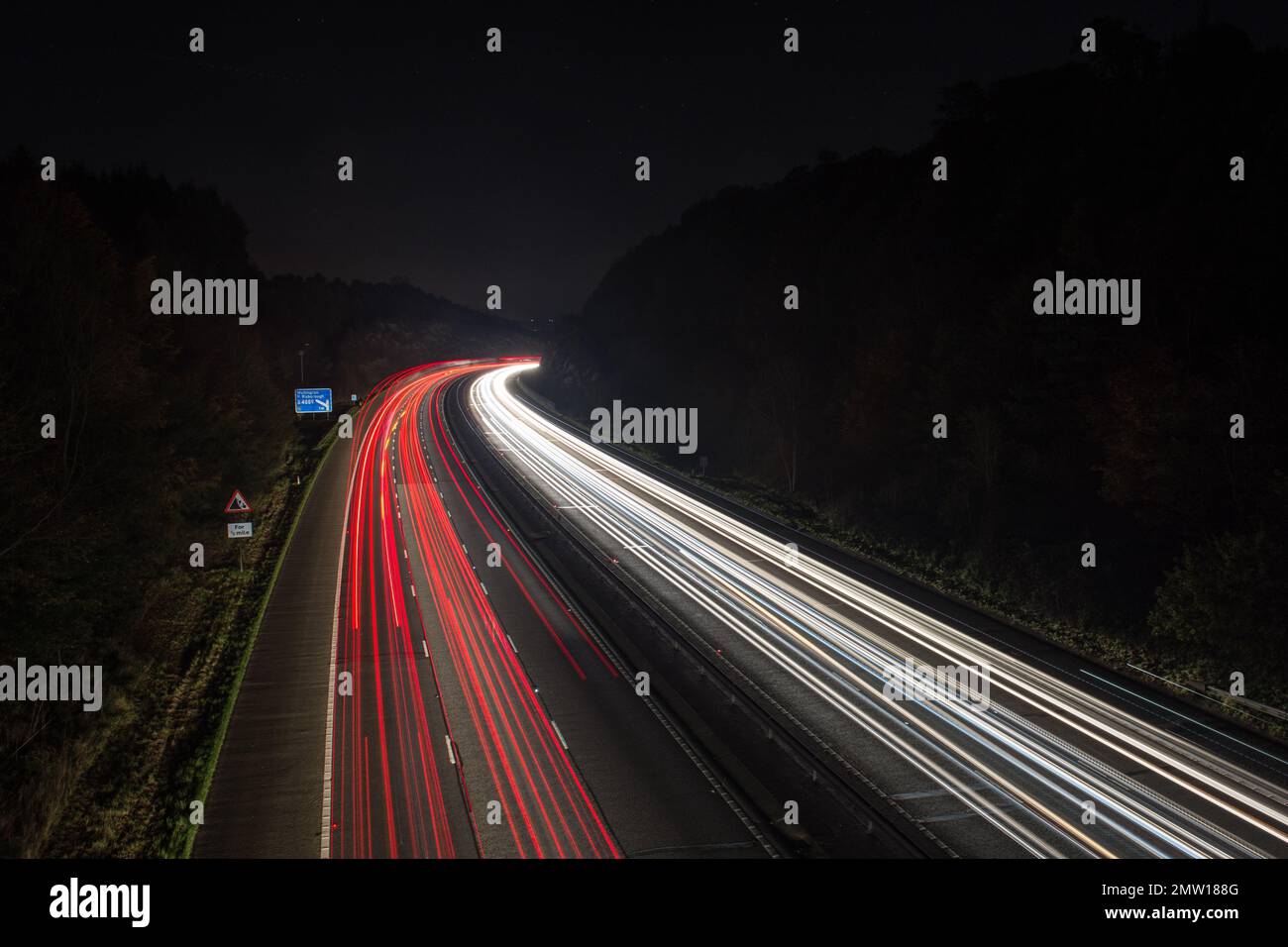 Light trails left by speeding traffic travelling through the night on ...