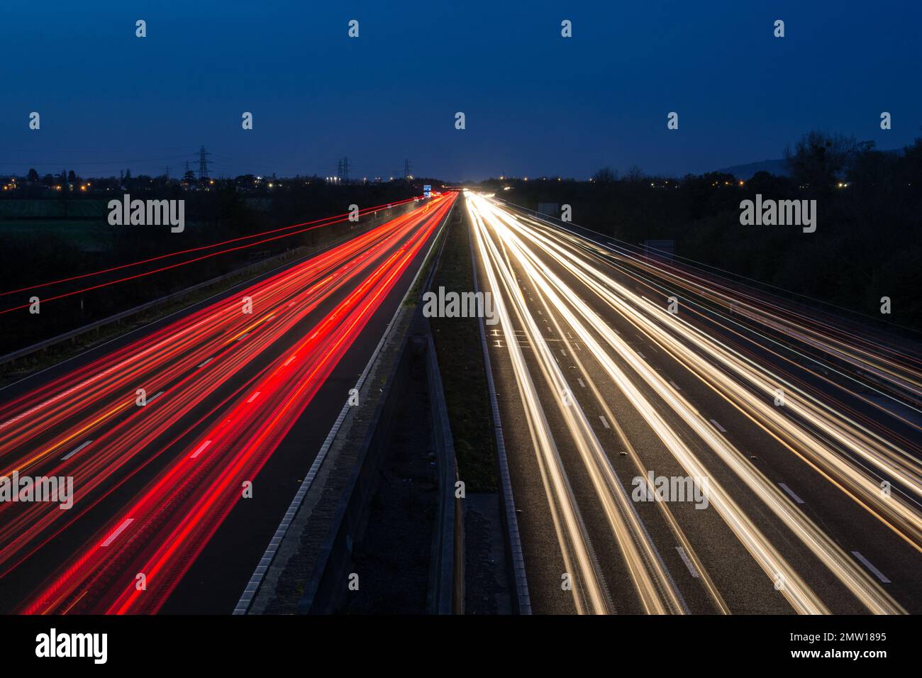 Light trails left by speeding traffic travelling through the night on ...