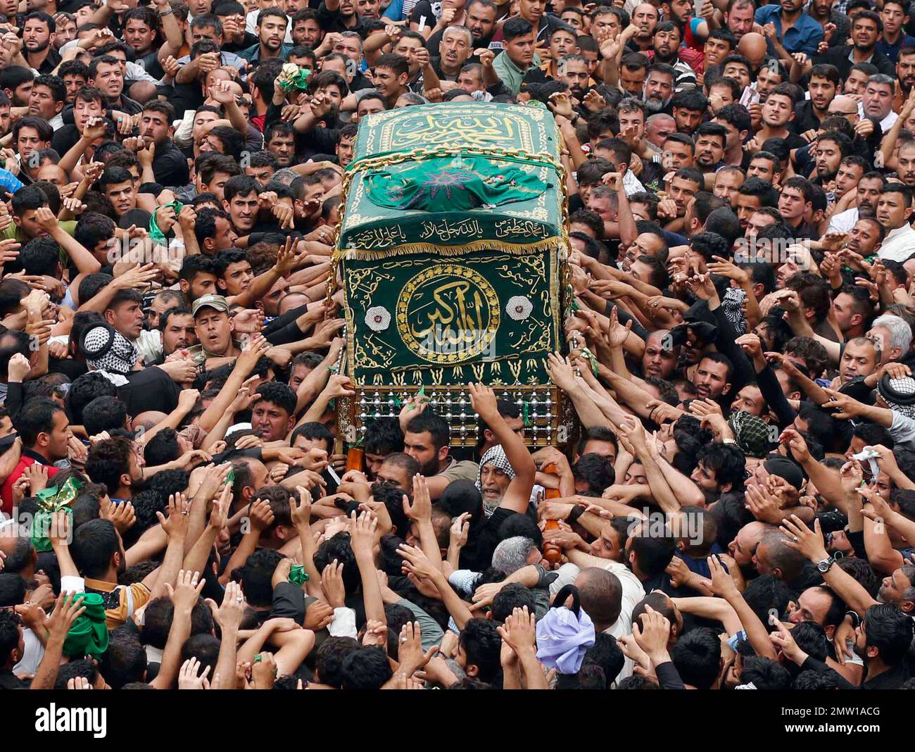 Shiite worshippers carry a symbolic coffin at the holy Shiite shrine of ...