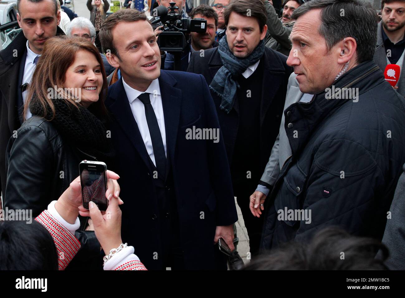 Centrist candidate Emmanuel Macron poses with a supporters before ...