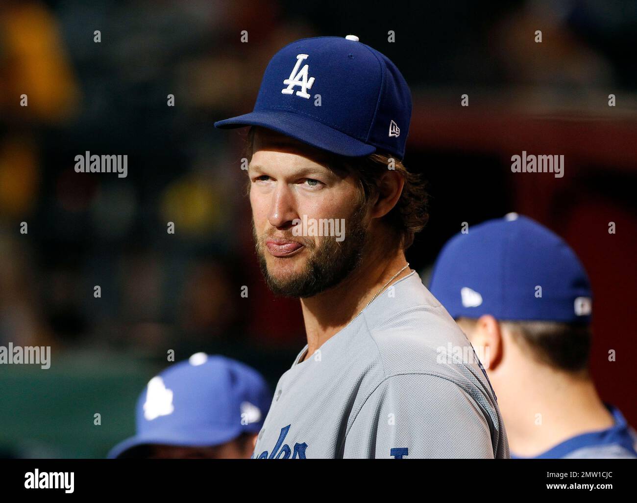 Los Angeles Dodgers' Clayton Kershaw looks on from the dugout before a ...
