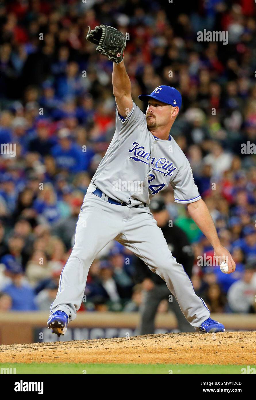 Kansas City Royals starting pitcher Travis Wood winds up to throw to ...