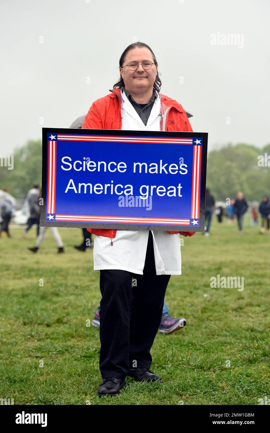 Seth Blackshaw from Baltimore, Md., poses for a portrait with a sign that reads "Science makes ...