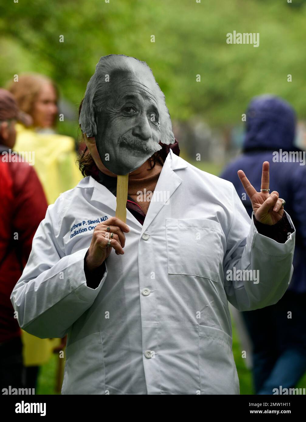 Ellen Taylor from Albany, N.Y., poses with an Albert Einstein mask for ...