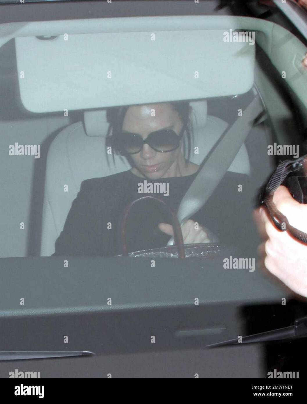 Victoria Beckham gets in her car after arriving on a flight at London ...