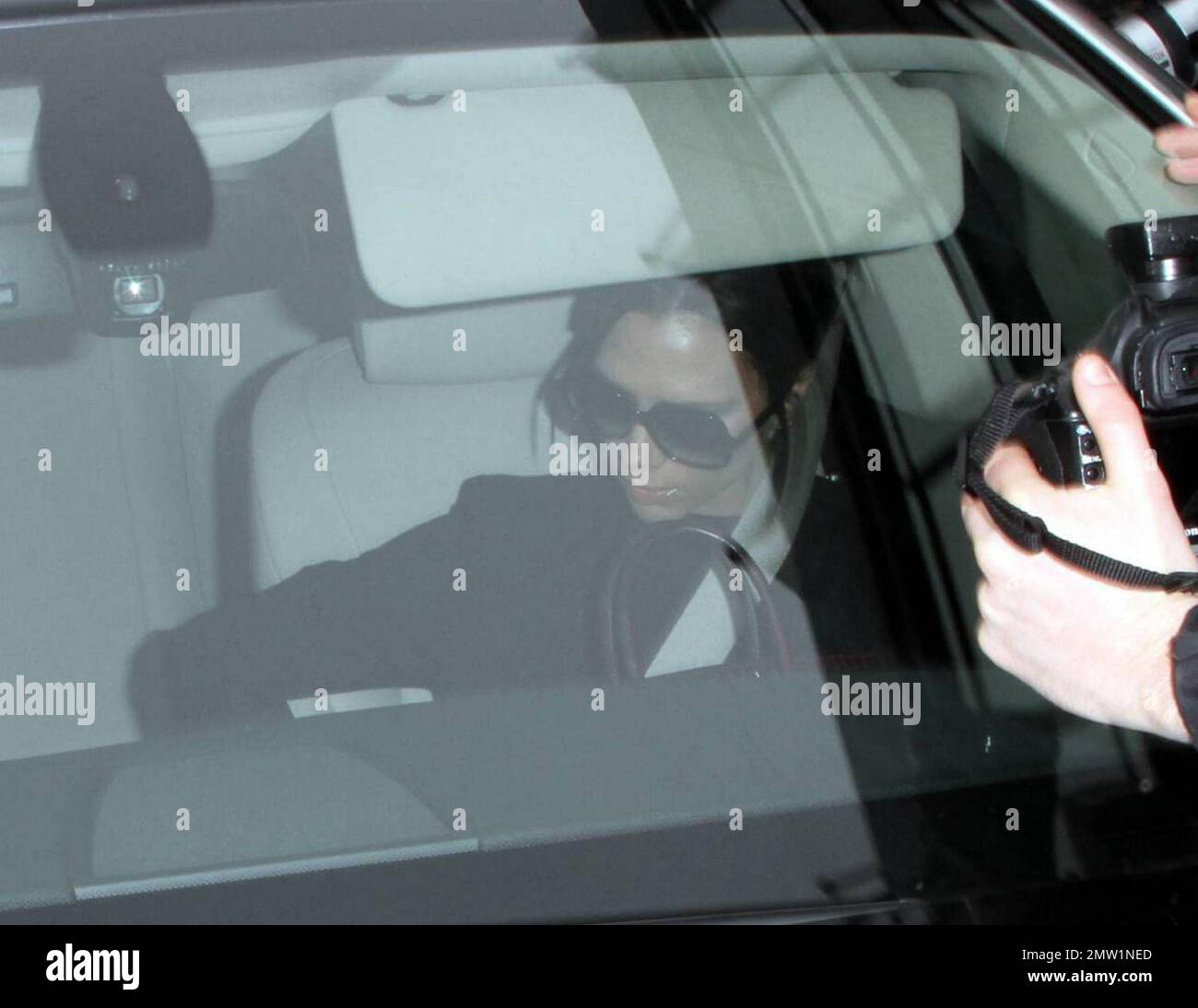 Victoria Beckham gets in her car after arriving on a flight at London ...