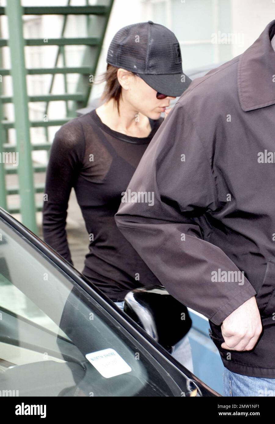 Victoria Beckham does her best to go incognito, leaving with bodyguards ...