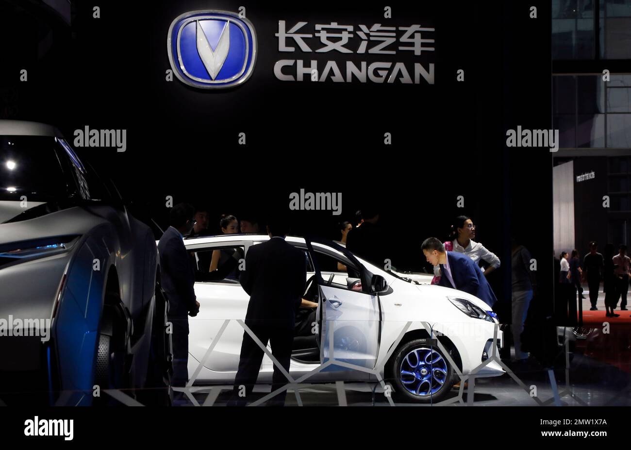 Visitors look at the latest vehicles from Chinese automaker Changan ...