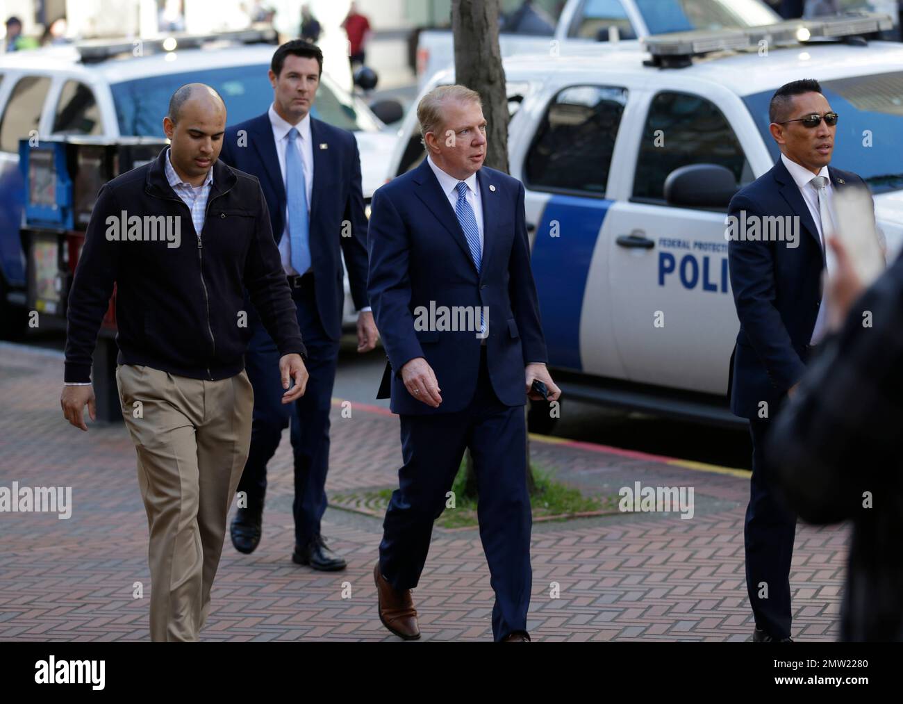 Seattle Mayor Ed Murray, third from left, walks near the scene of a ...