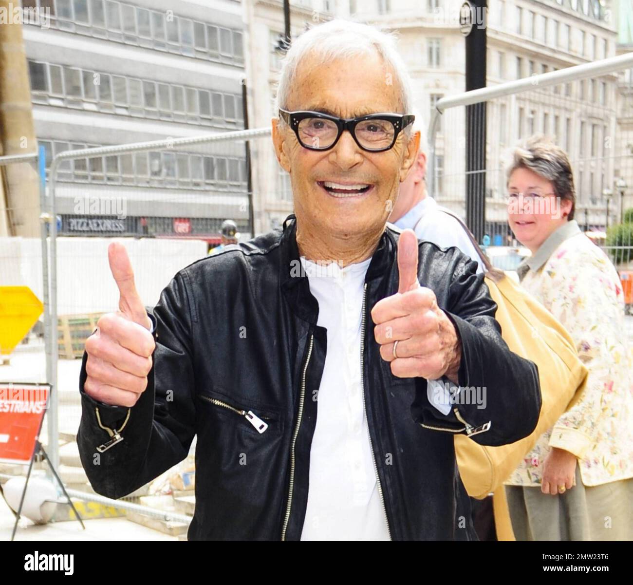 Hairdresser and businessman Vidal Sassoon gives the thumbs up while out ...